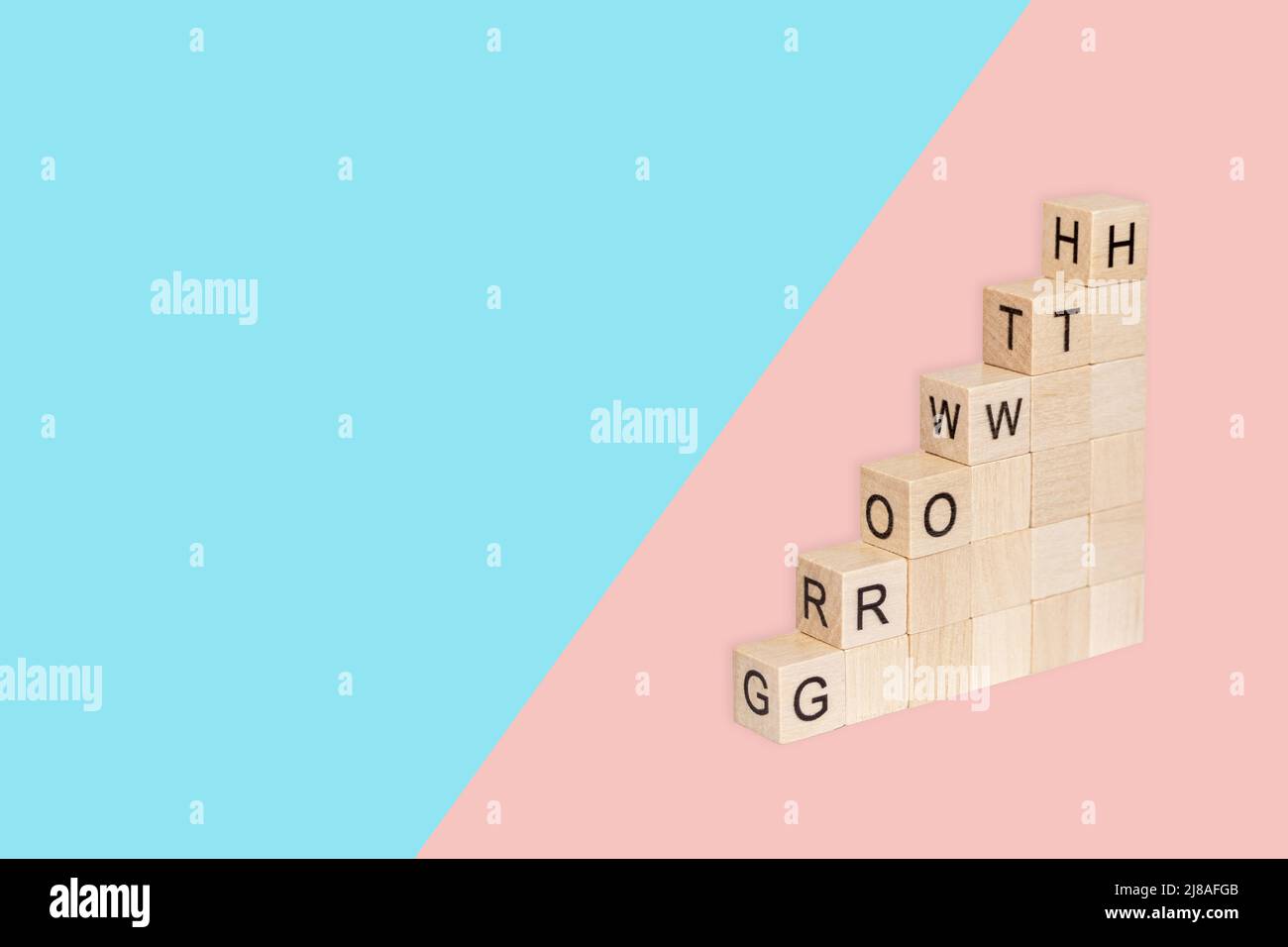 Wooden cubes block which print screen growth wording on blue and pink background. Target of ...