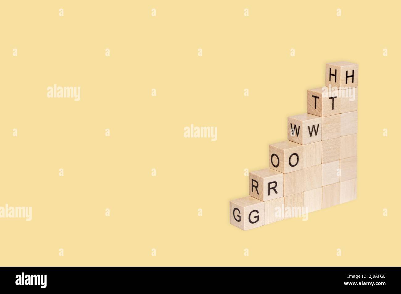 Wooden cubes block which print screen growth wording on yellow ...