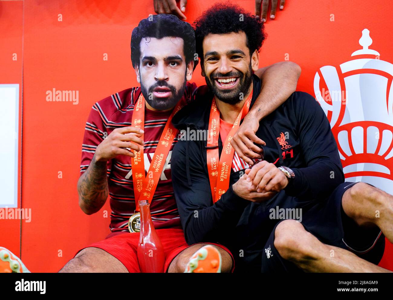 Liverpool's Thiago Alcantara (left) wears a Mohamed Salah mask as he ...