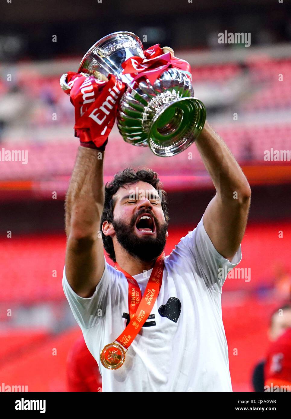 Liverpool goalkeeper Alisson celebrates with the trophy at the end of ...