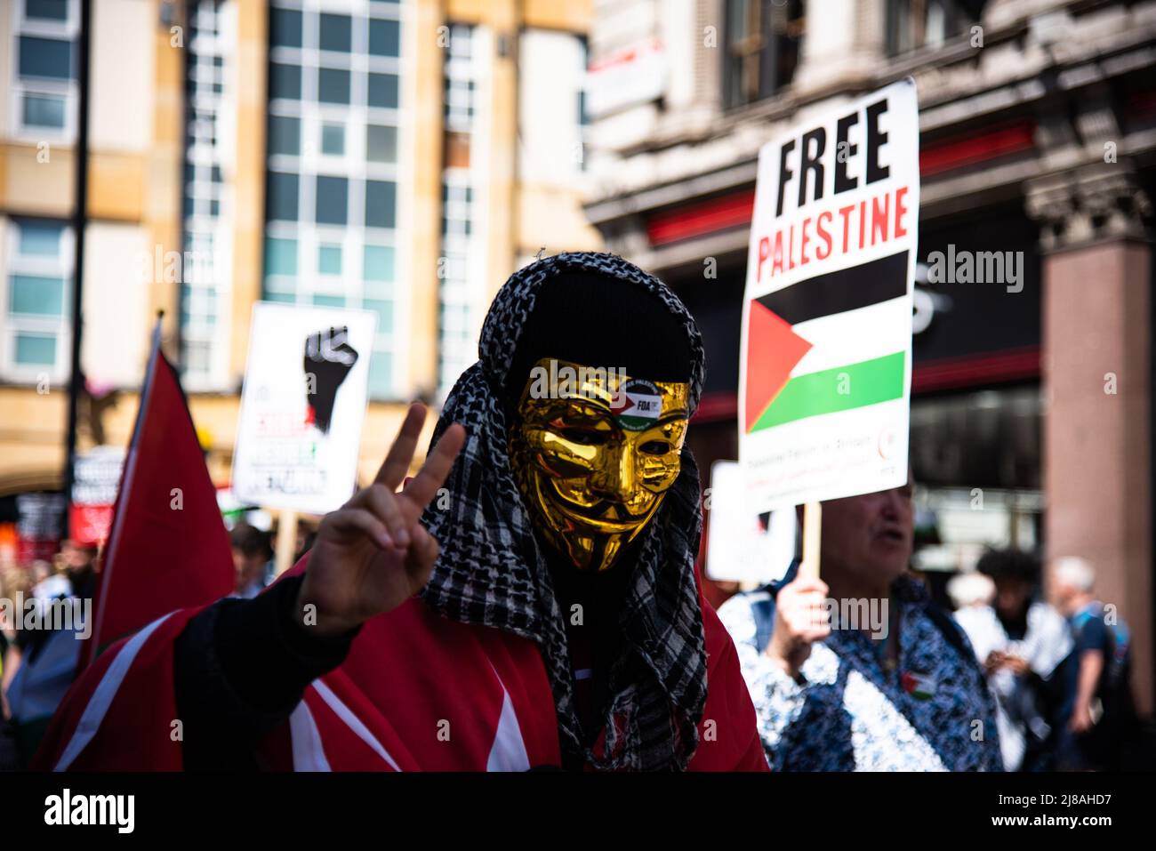 London, UK. 14th May, 2022. A masked protestor marches during the ...