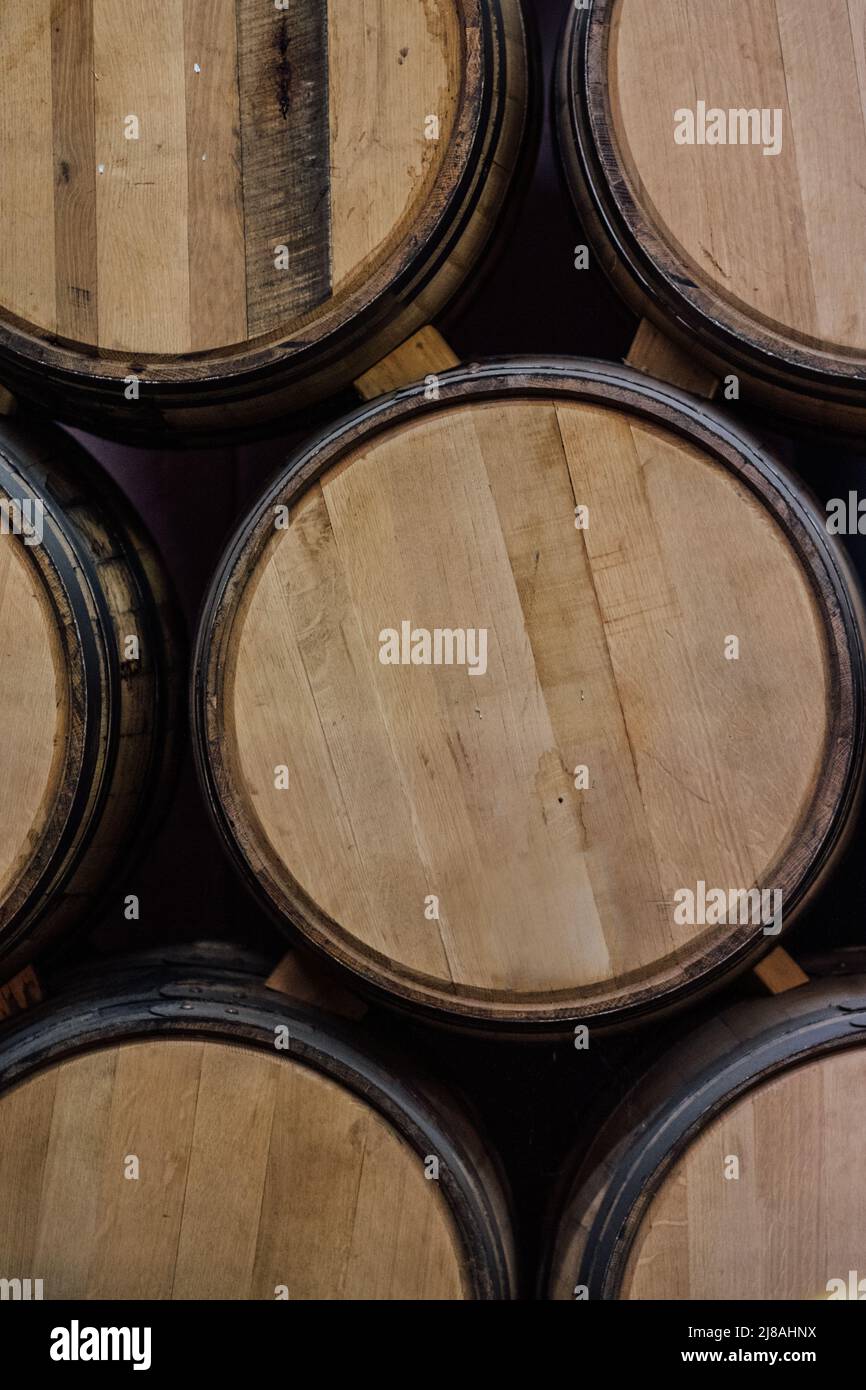 unlabeled American oak whiskey barrels stacked on each other using ...