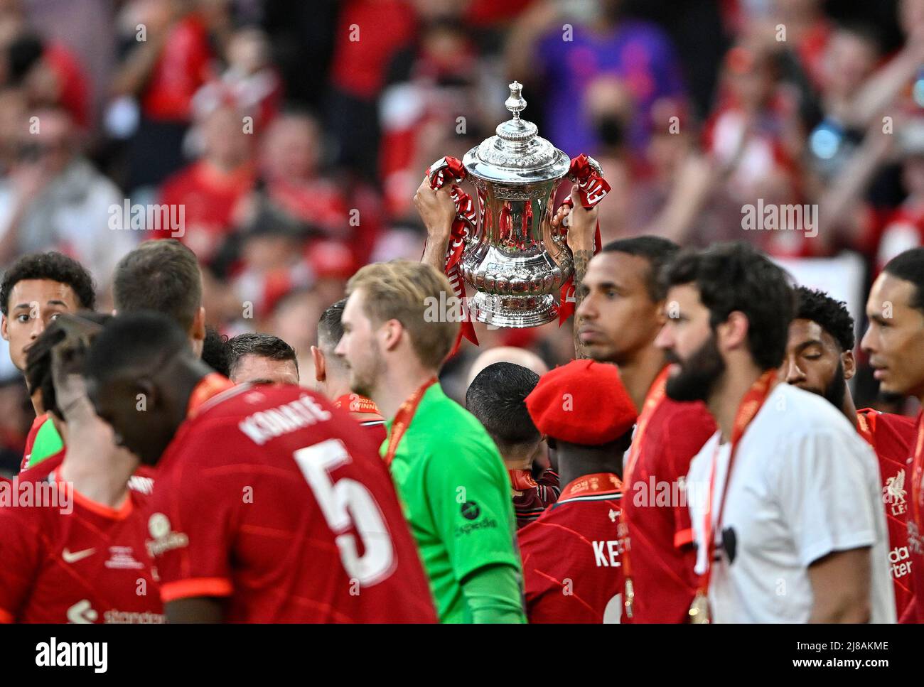 London, UK. 14th May, 2022. The cup is raised as the Liverpool team ...