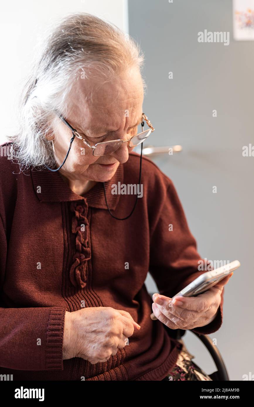 83 Year Old Grandmother Having A Video Call Sitting In A Wheelchair