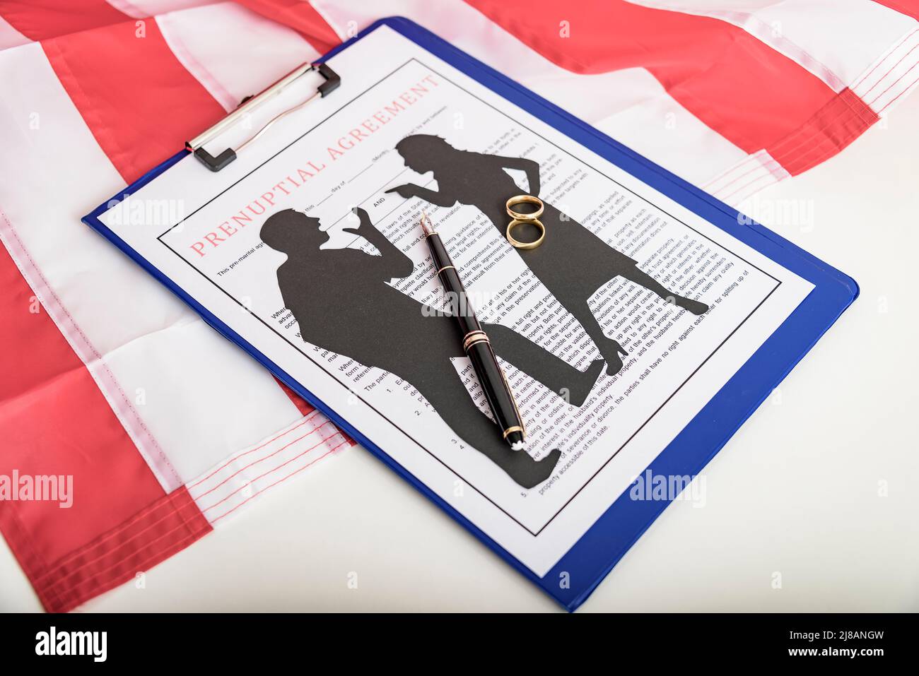 Marriage contract with two golden wedding rings and gold pen ...