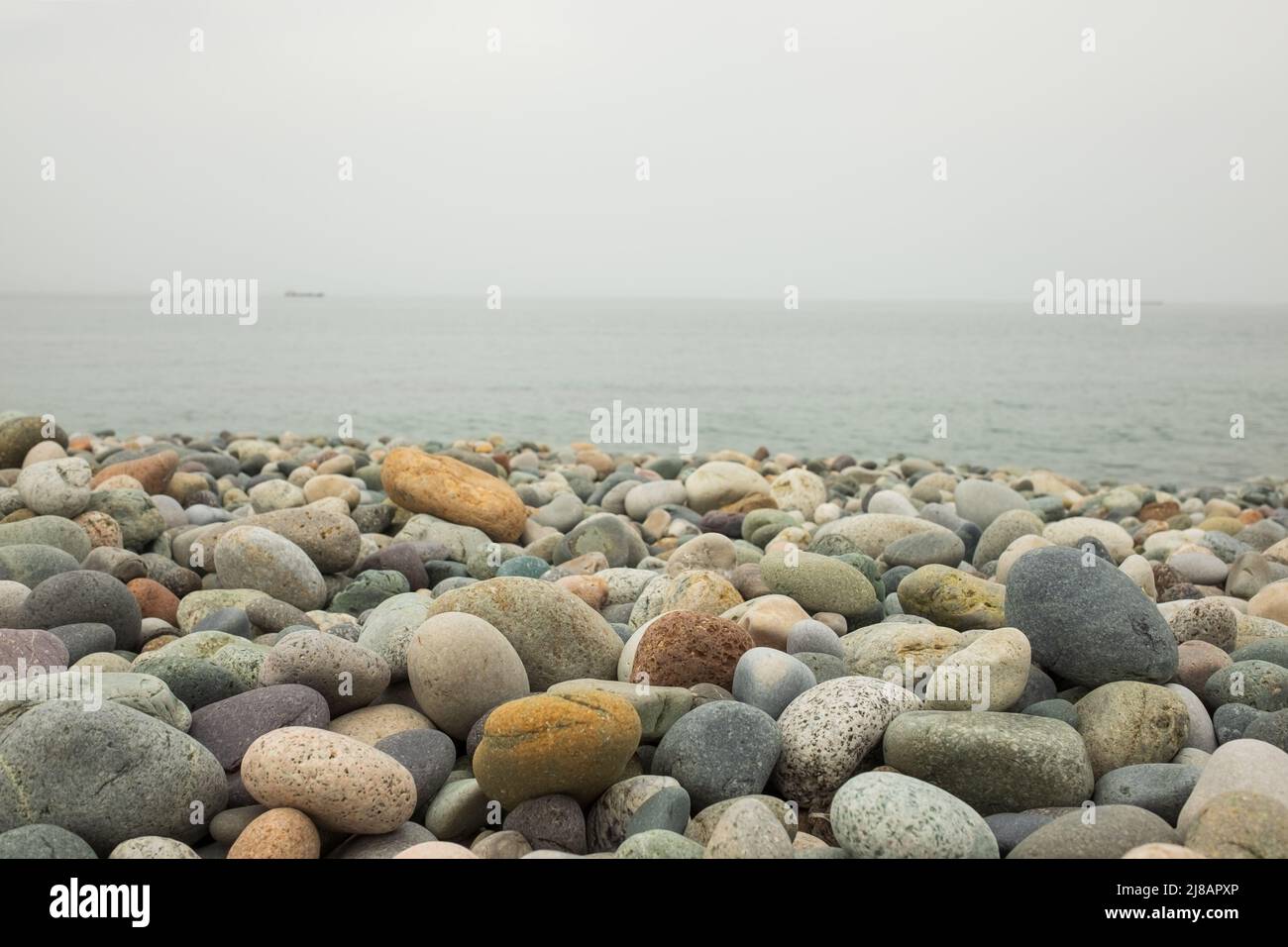 Sea stones background in the seaside on a beach. A close up view of ...