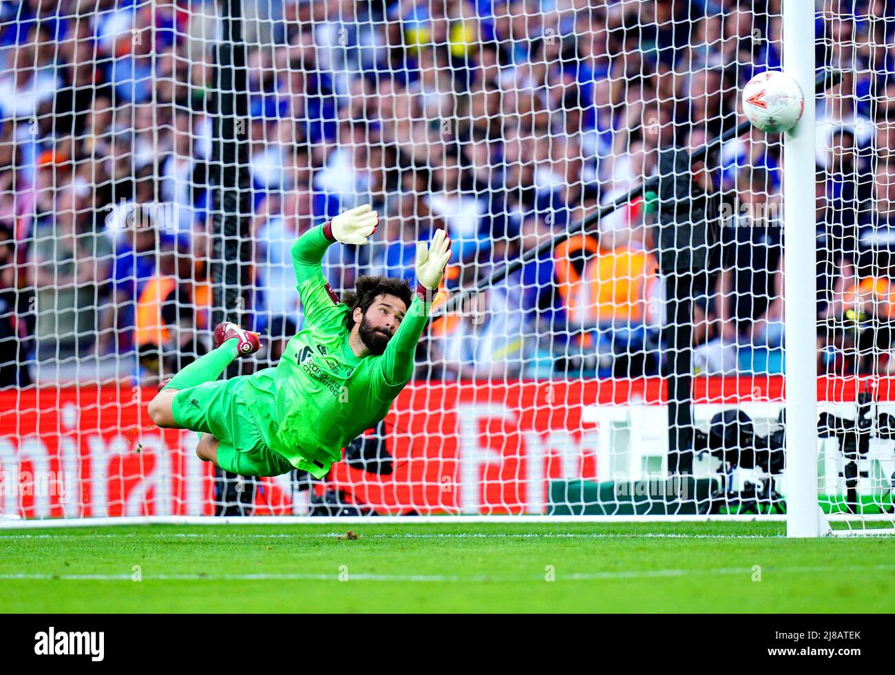 Liverpool goalkeeper Alisson dives as a penalty from Chelsea's Cesar ...
