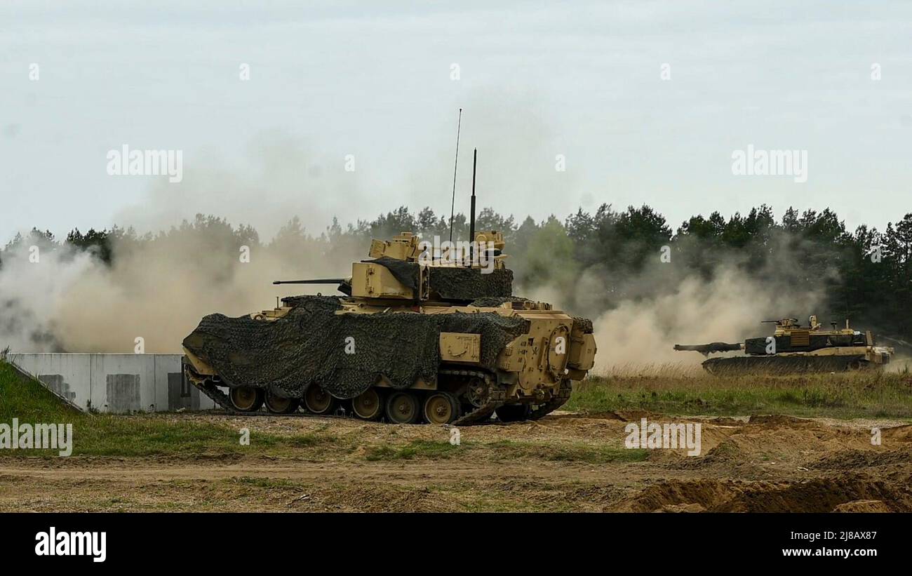 A U.S. Army M2A3 Bradley Infantry Fighting Vehicle and a U.S. Army M1A2 ...