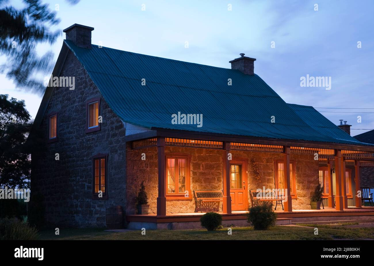 Old circa 1850 style cut stone home at dusk Stock Photo - Alamy