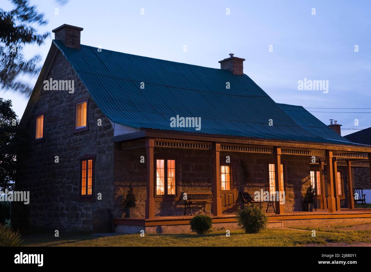 Old circa 1850 style cut stone home at dusk Stock Photo - Alamy