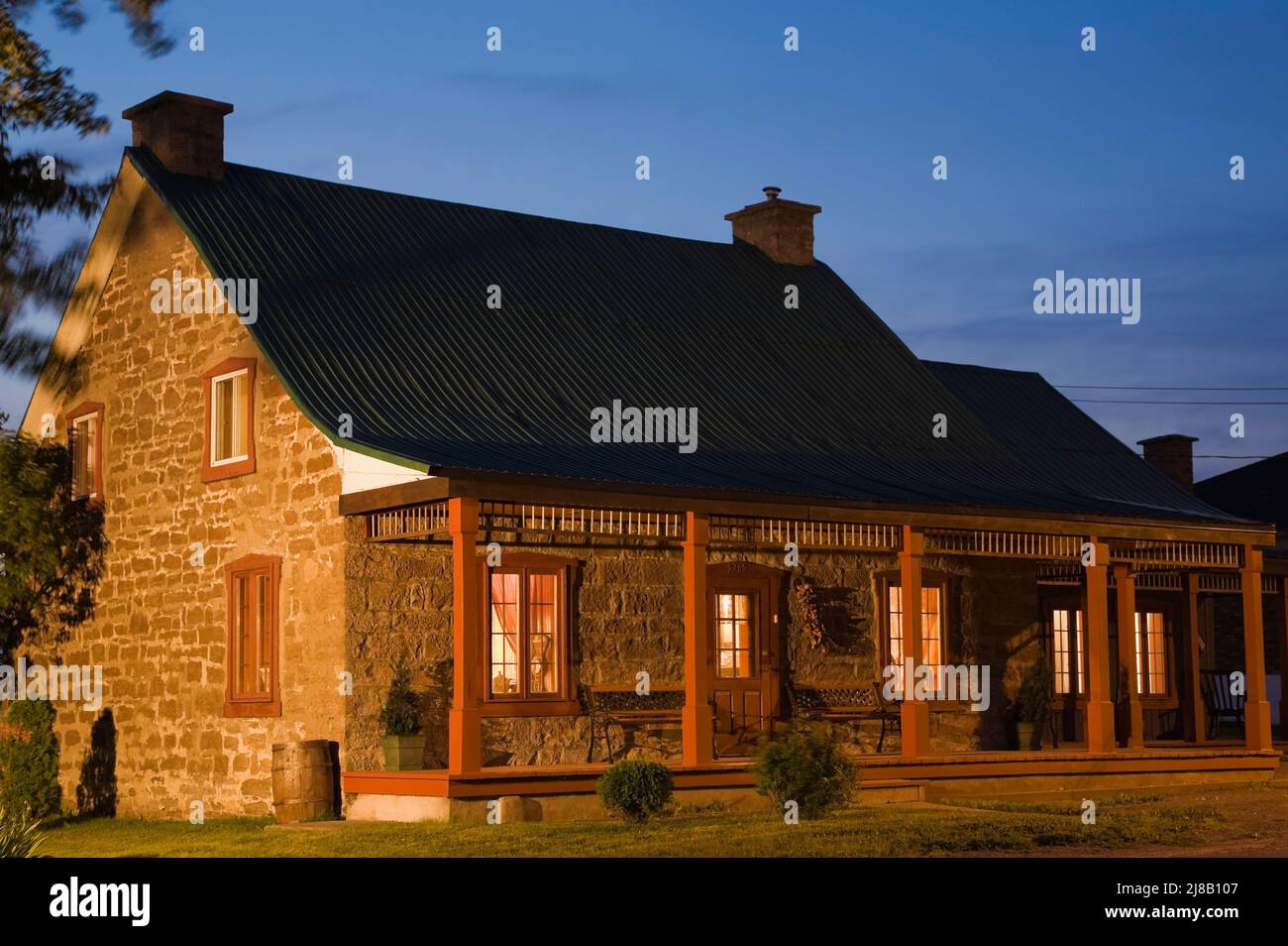 Old circa 1850 style cut stone home at dusk Stock Photo - Alamy
