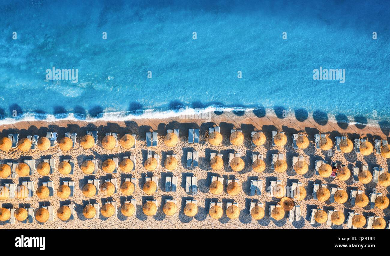 Aerial view of sea, empty sandy beach with sunbeds and umbrellas Stock ...