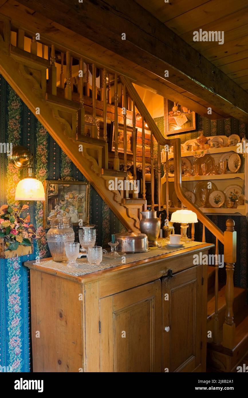 Antique wooden cabinets and pinewood staircase in kitchen inside old ...
