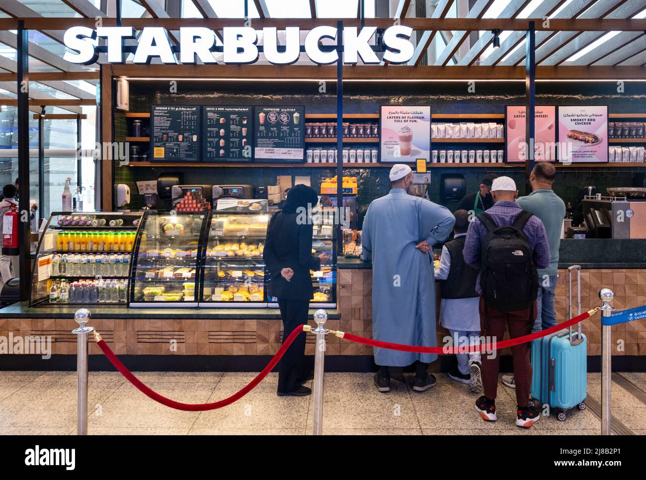Customers queue at the American multinational chain Starbucks Coffee ...