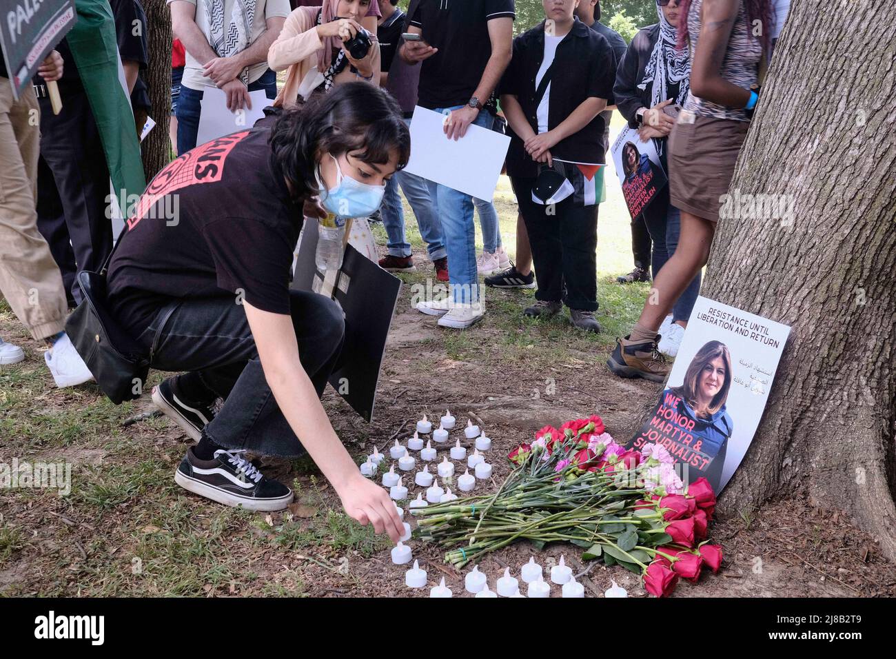 Atlanta, Georgia, USA. 14th May, 2022. A mourner places a candle at a ...