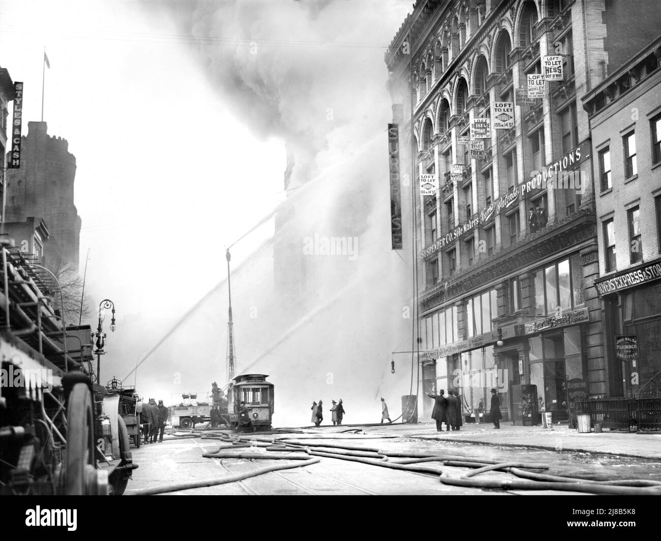 Fireman spraying water on burning building, 14th Street, New York City ...