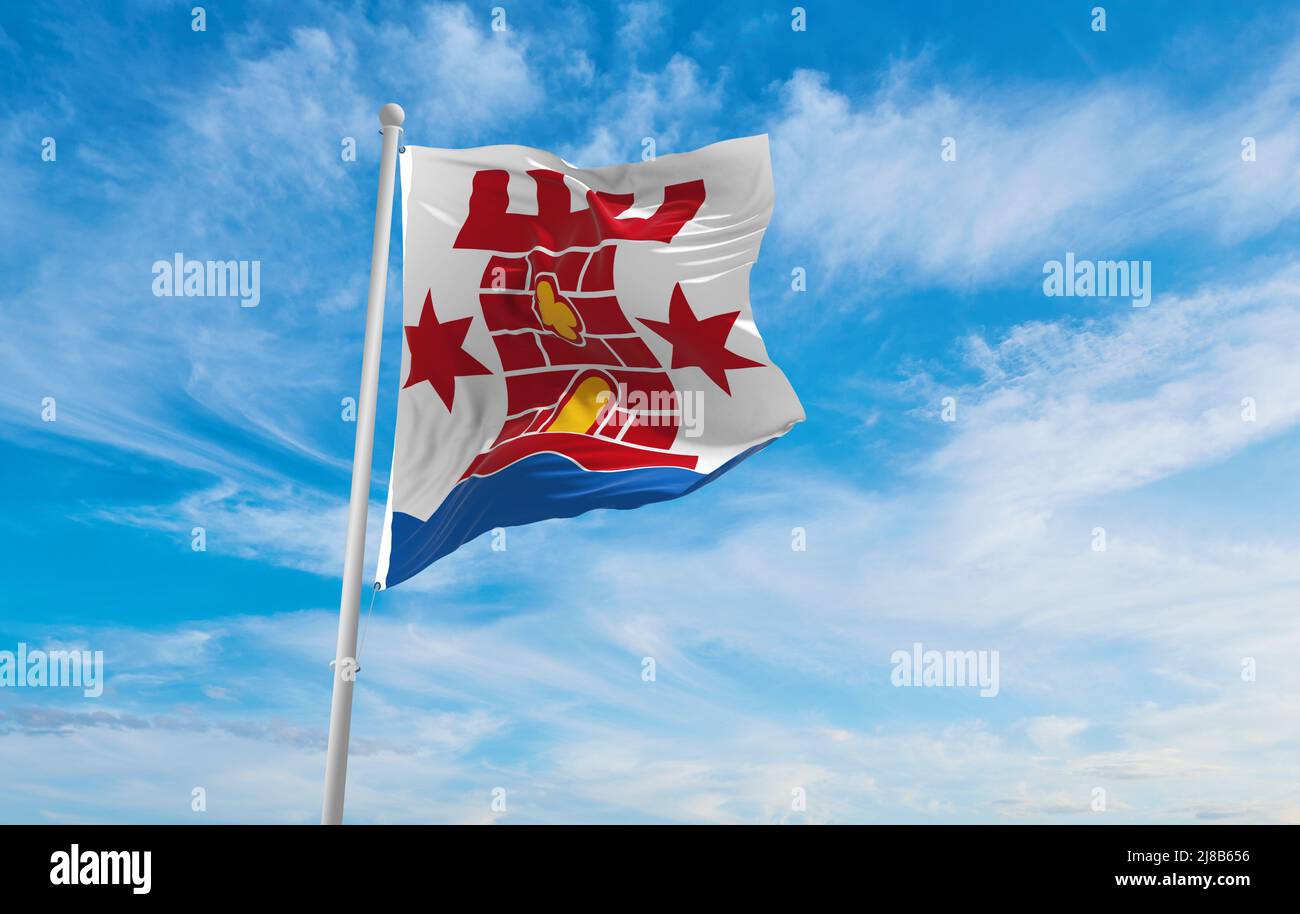 official flag of Kalmar kommun , Sweden at cloudy sky background on ...