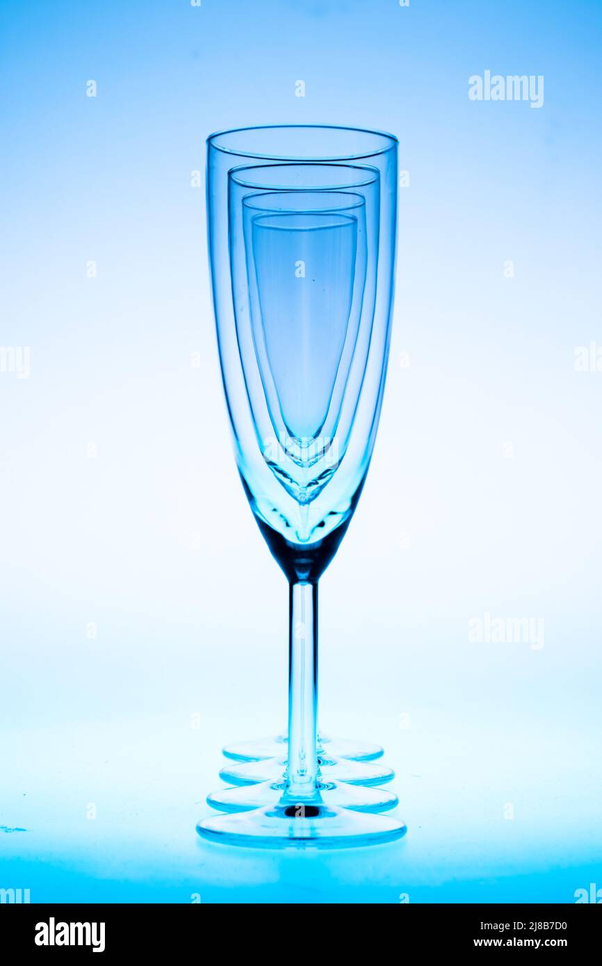 Glasses in art form in a blue world Stock Photo - Alamy