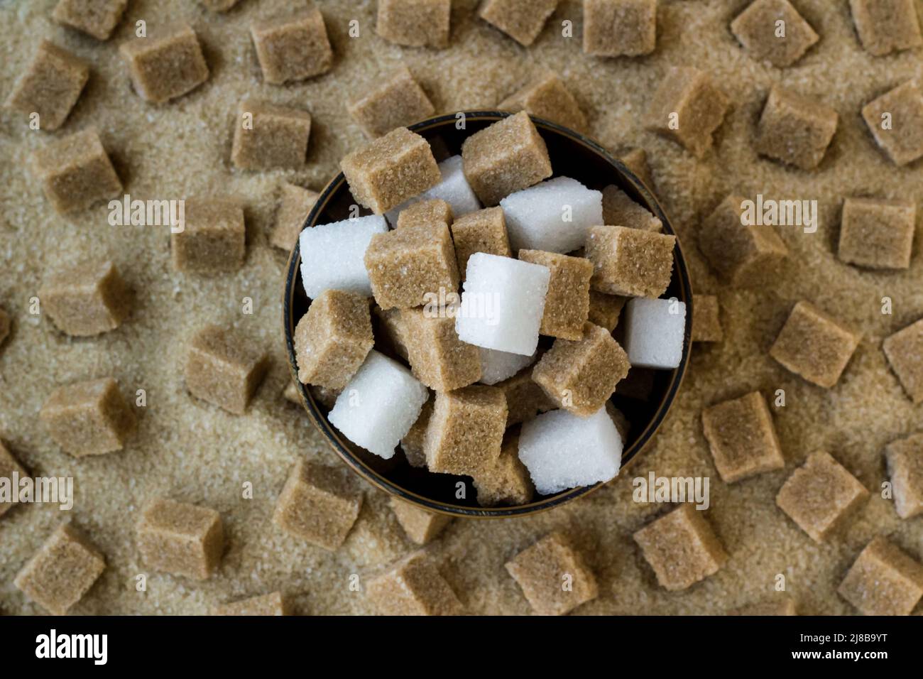 Natural,brown sugar cubes designed in bamboo bowl with white sugar ...