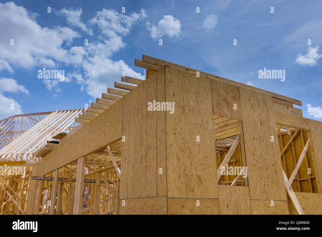Exterior view of a new house under construction framing Stock Photo - Alamy