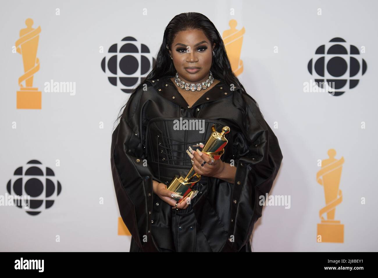 Savannah Re pose for a photograph at the media wall after winning the ...