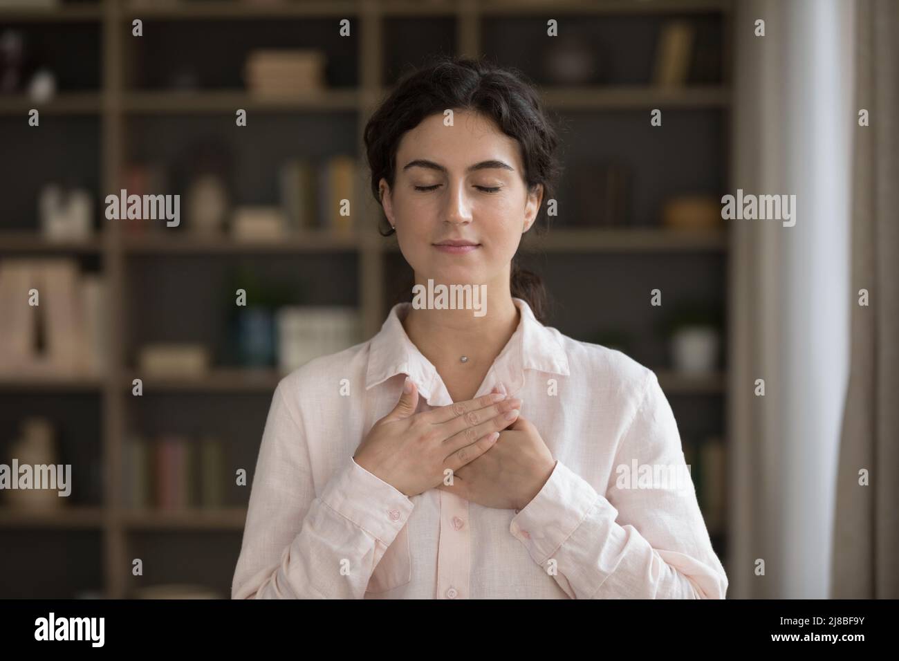 Hands folded on chest hi-res stock photography and images - Alamy