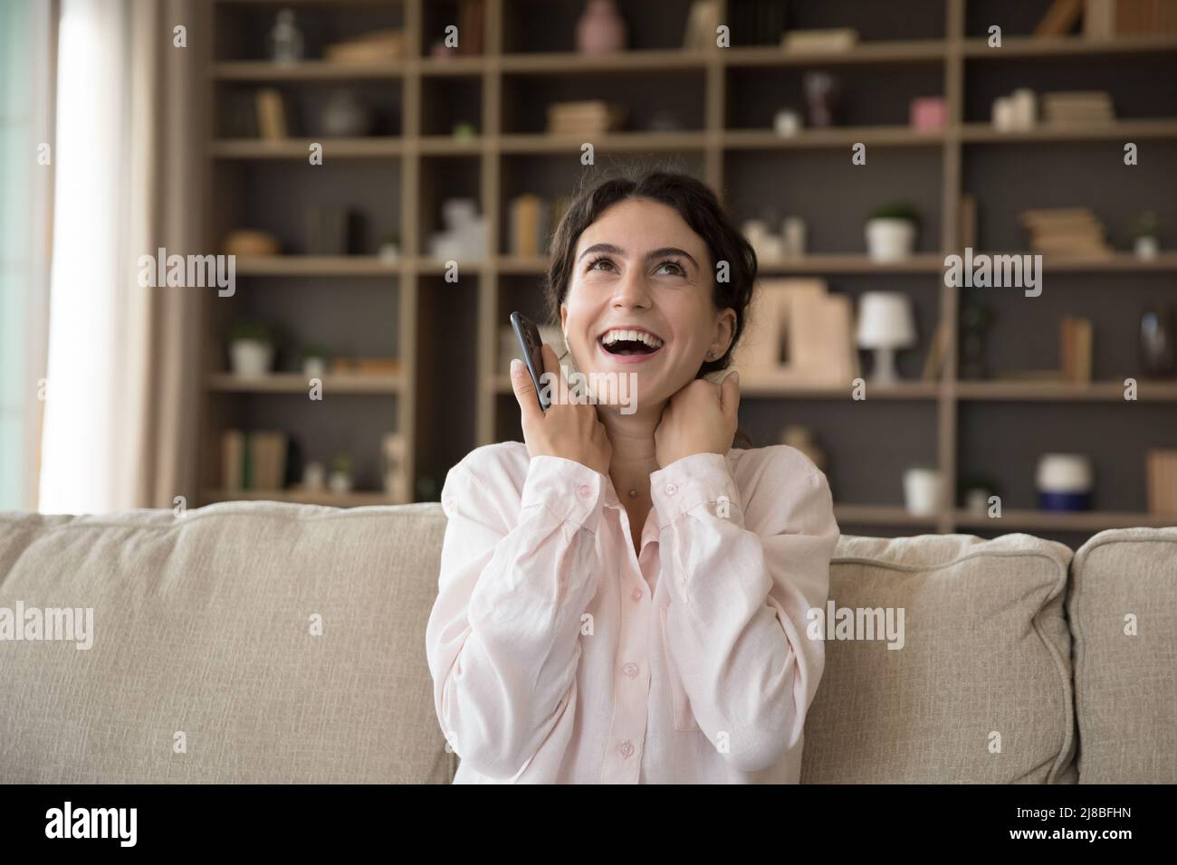 Excited young woman winner looks hi-res stock photography and images ...