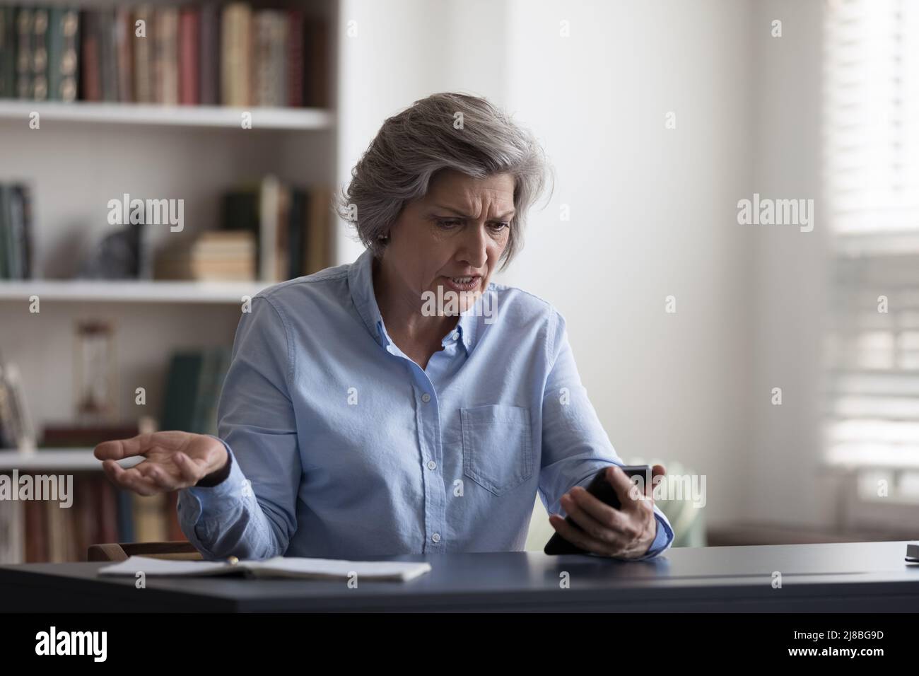 Frustrated angry elder lady annoyed with wrong work of app Stock Photo ...