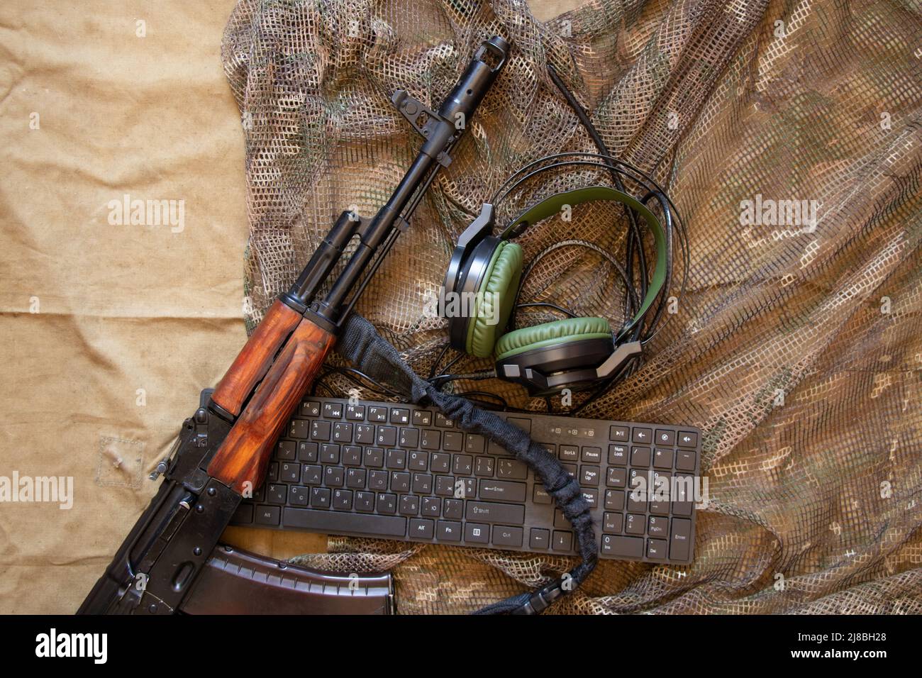 The keyboard of a military combat machine and headphones lie on a ...