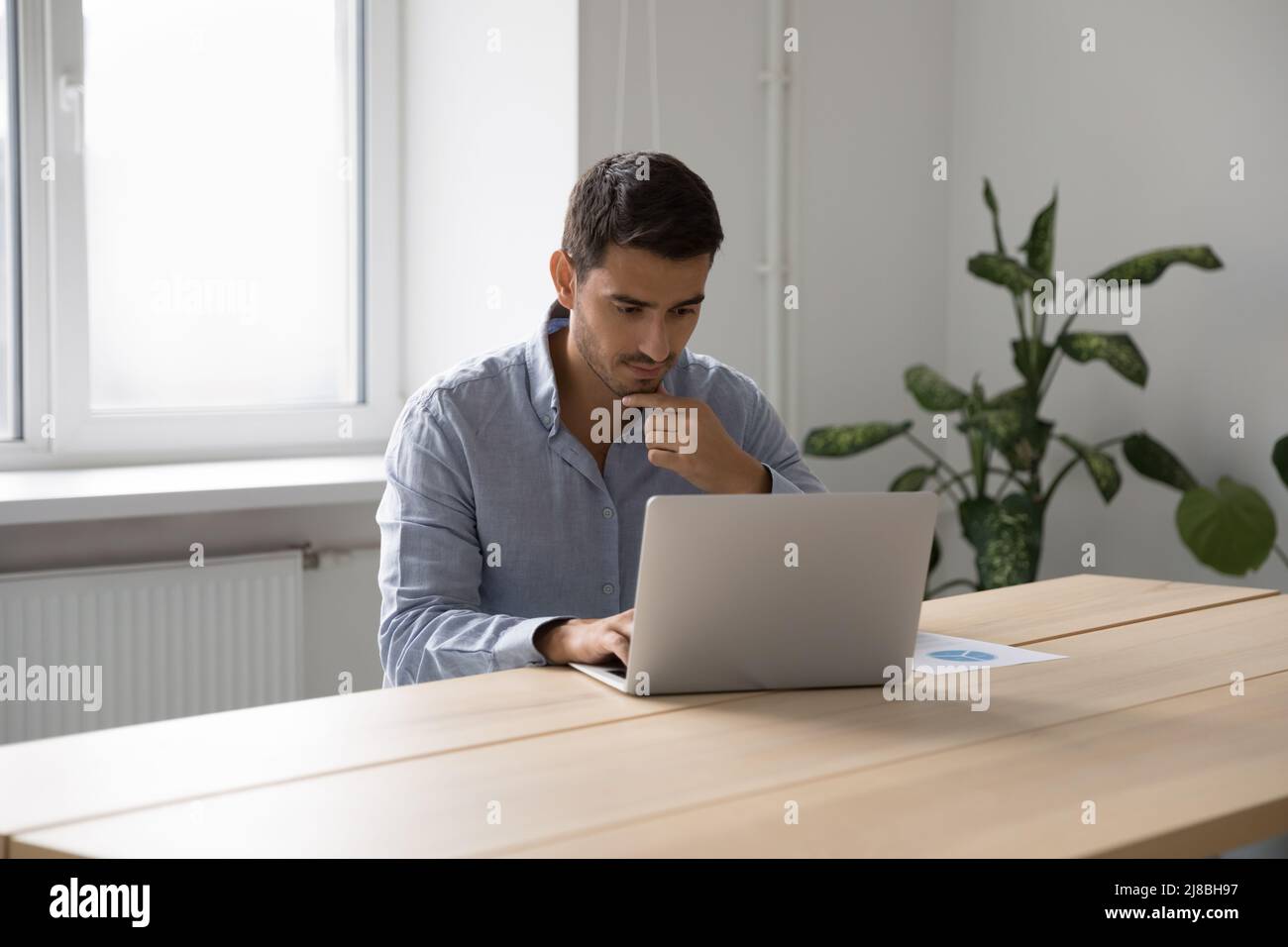 Focused thoughtful freelance worker man thinking over project Stock ...
