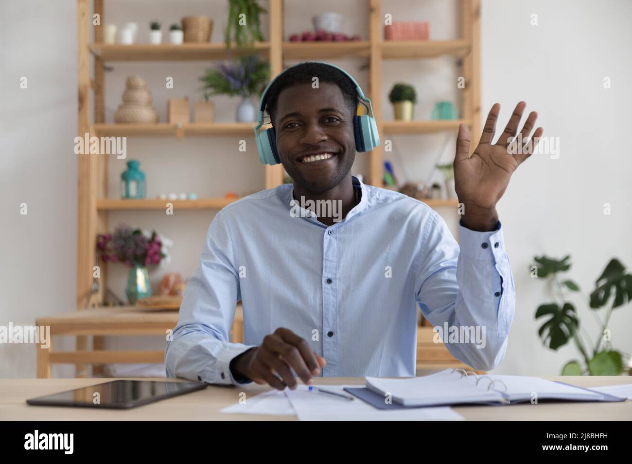 Happy African coach, business blogger greeting audience Stock Photo - Alamy