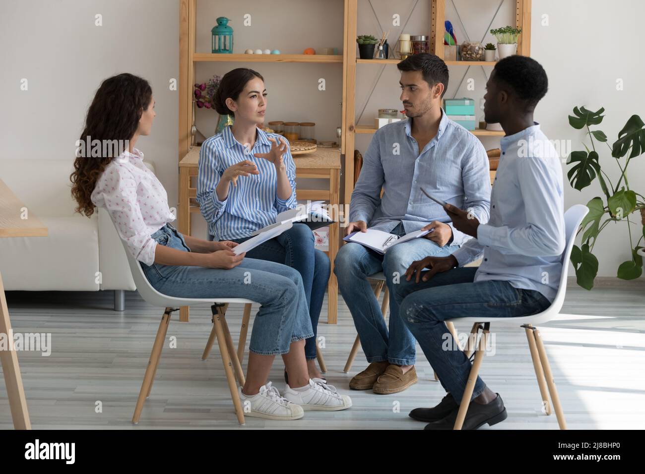 Serious diverse team meeting for group therapy, sitting in circle Stock ...