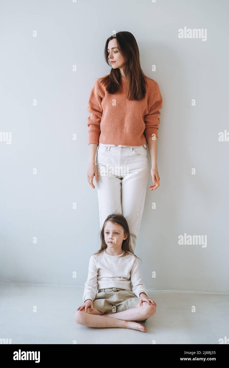 Vertical portrait in natural tones of Young parent woman mother with ...