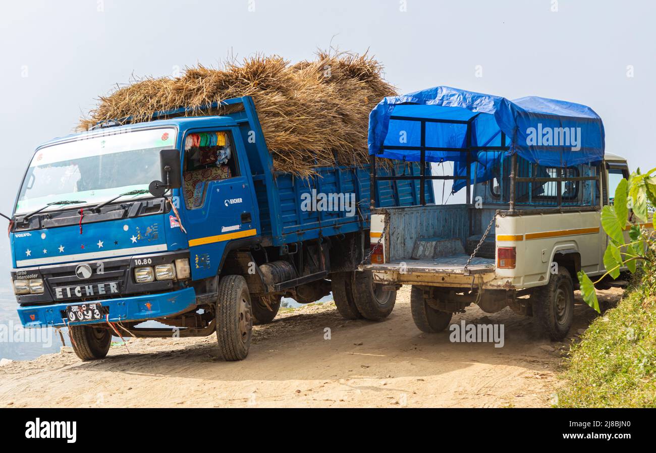 Nepal - October 29, 2021: Two vehicles meet on a narrow mountain road ...