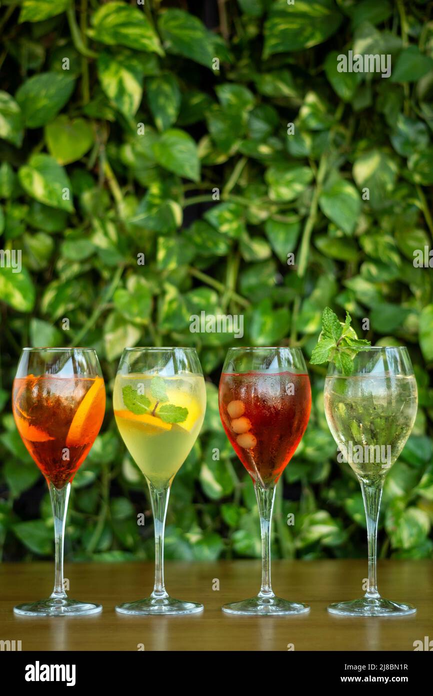 mixed spritzer wine cocktails selection with fruit in outdoor bar table ...