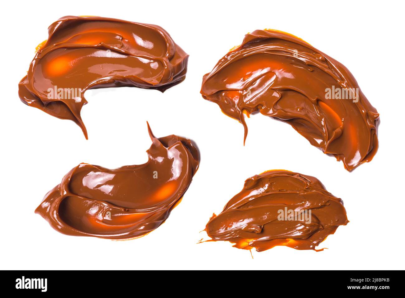Melted tasty caramel splashes isolated on white background Stock Photo ...