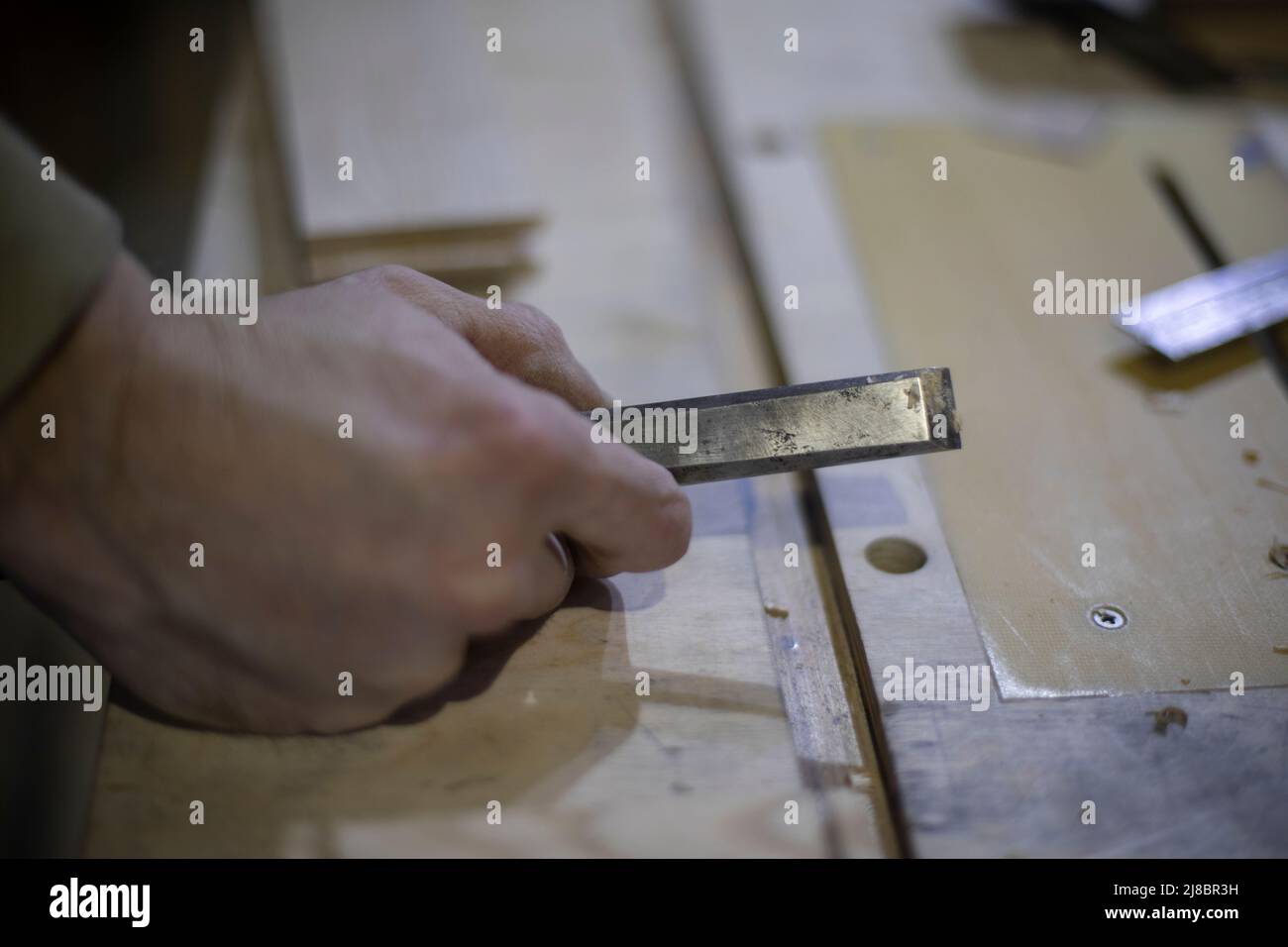 Cutter in hand of carpenter. Wood cutting tool. Details of carpentry ...
