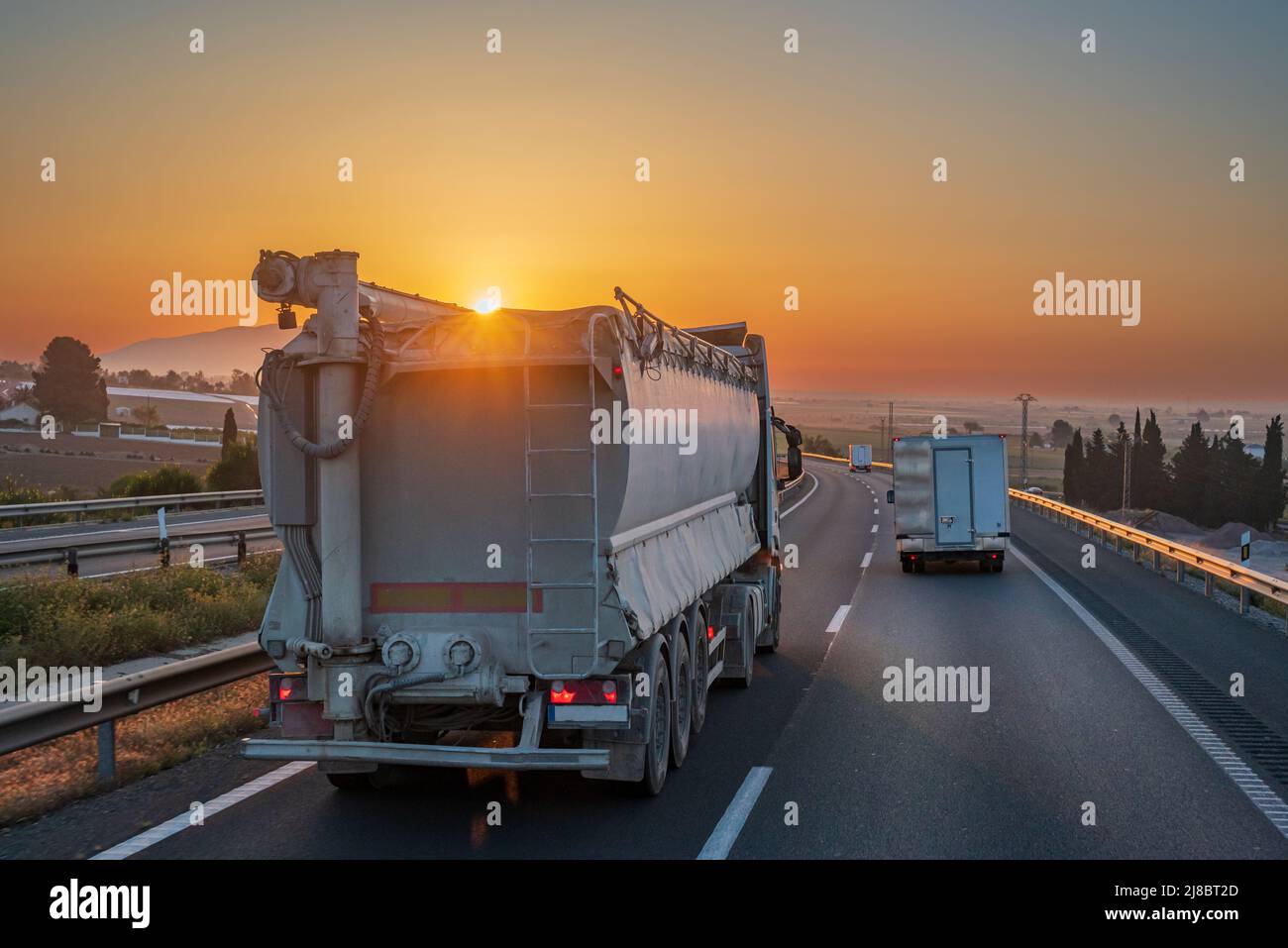 Truck with specific semi-trailer for the transport of feed for animal ...