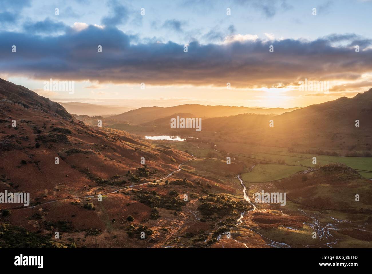 Epic aerial drone landscape image of sunrise from Blea Tarn in Lake ...