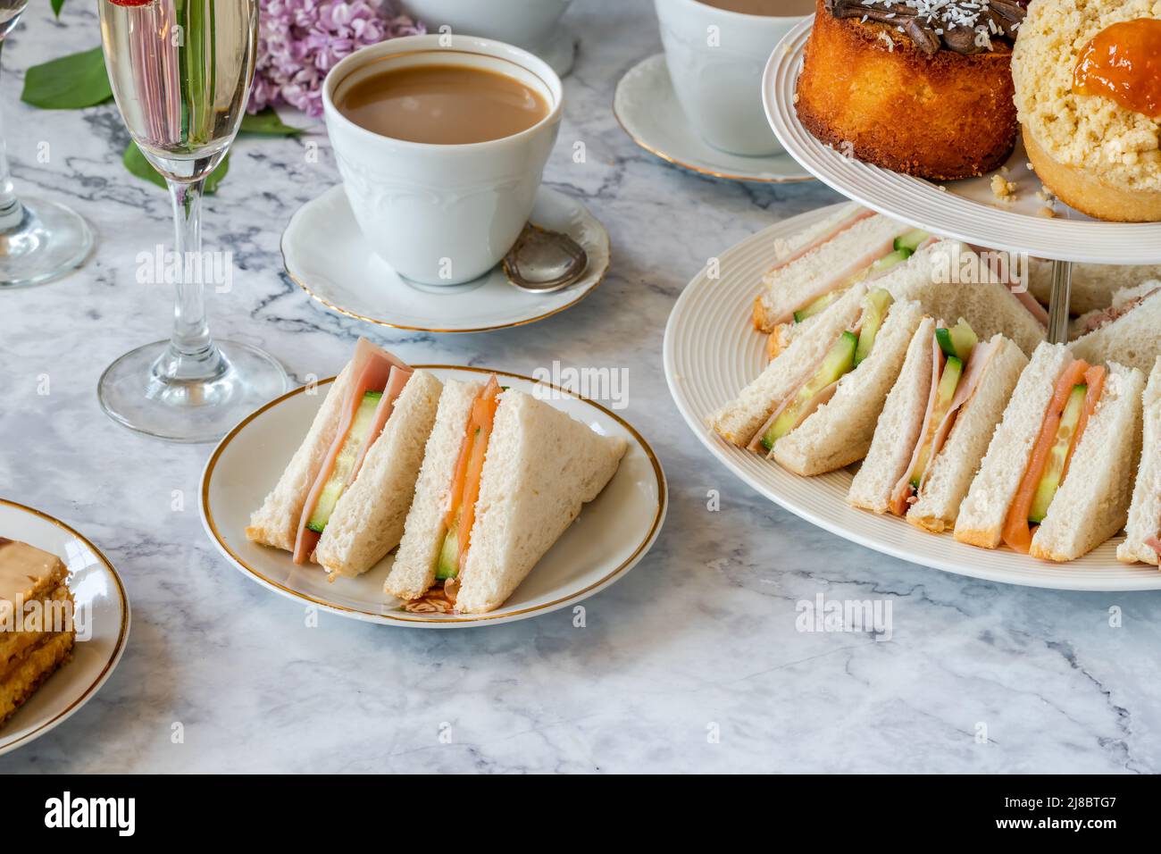 Selection of gourmet cakes and mini canapes with coffee and sparkling ...