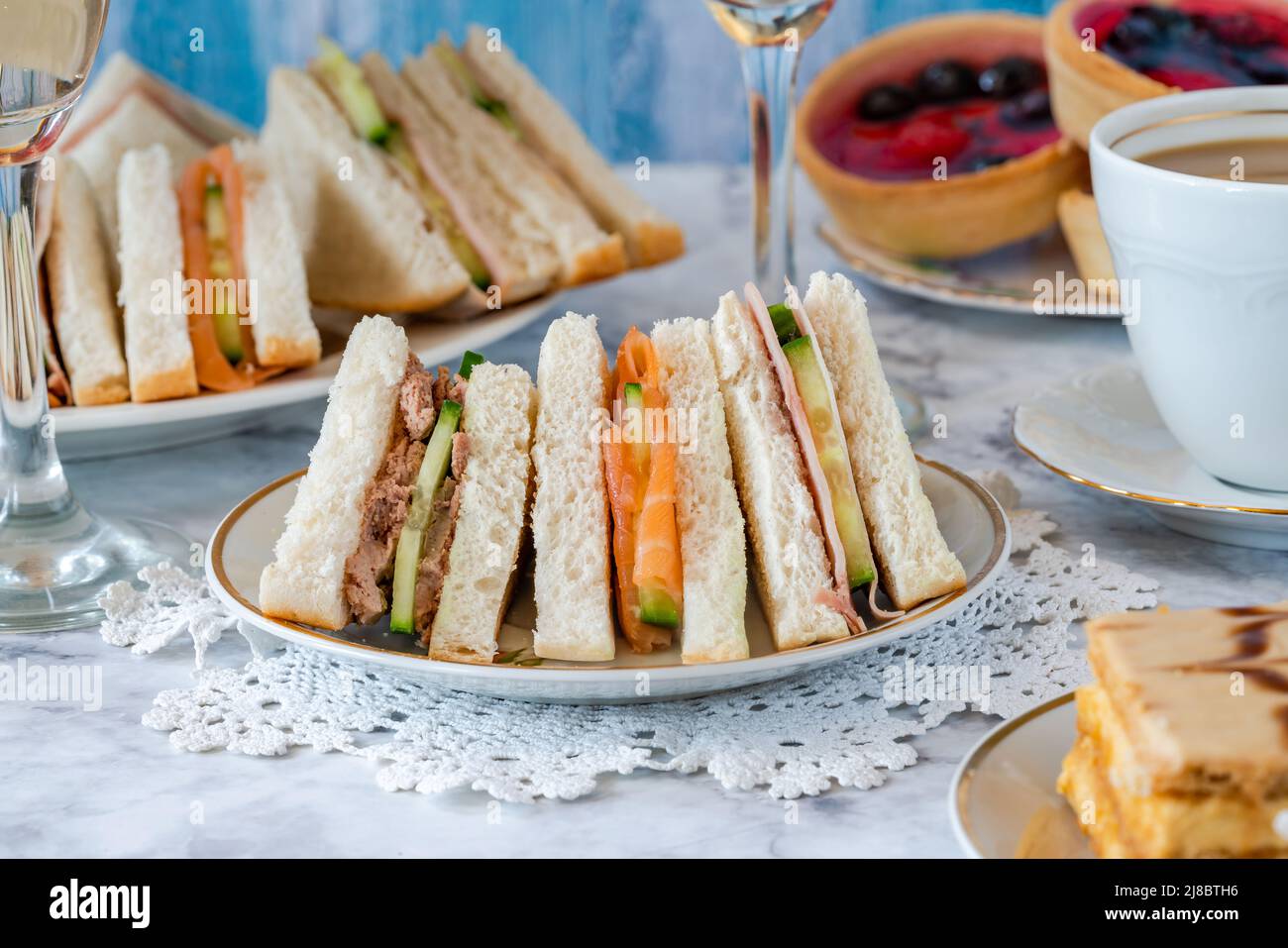 Selection of gourmet cakes and mini canapes with coffee and sparkling ...