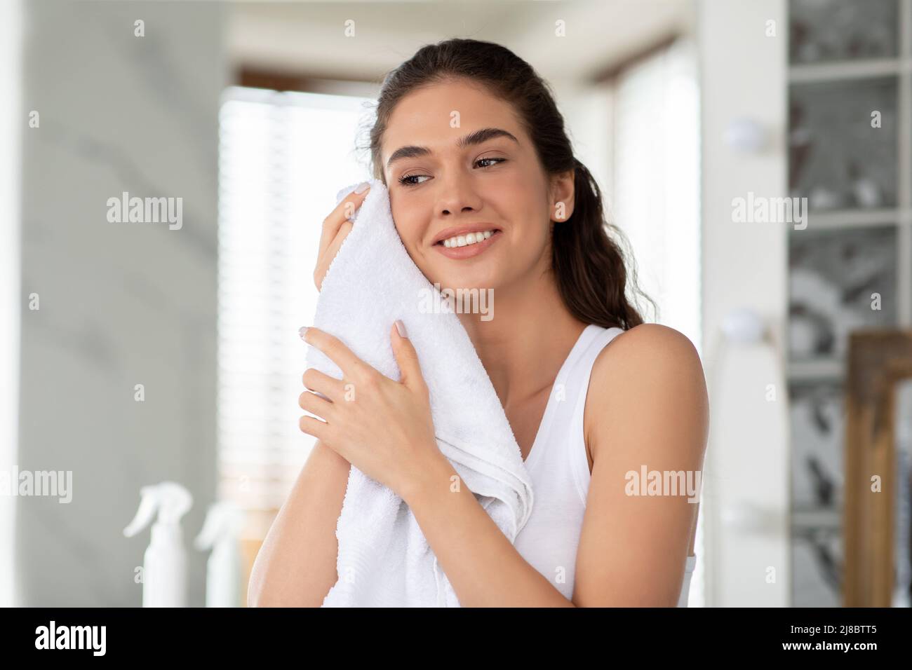 Happy Female Drying Face With Towel Standing In Modern Bathroom Stock ...