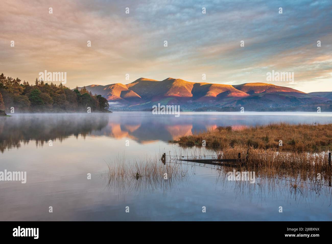 Epic Autumn sunrise landscape image looking from Manesty Park in Lake ...