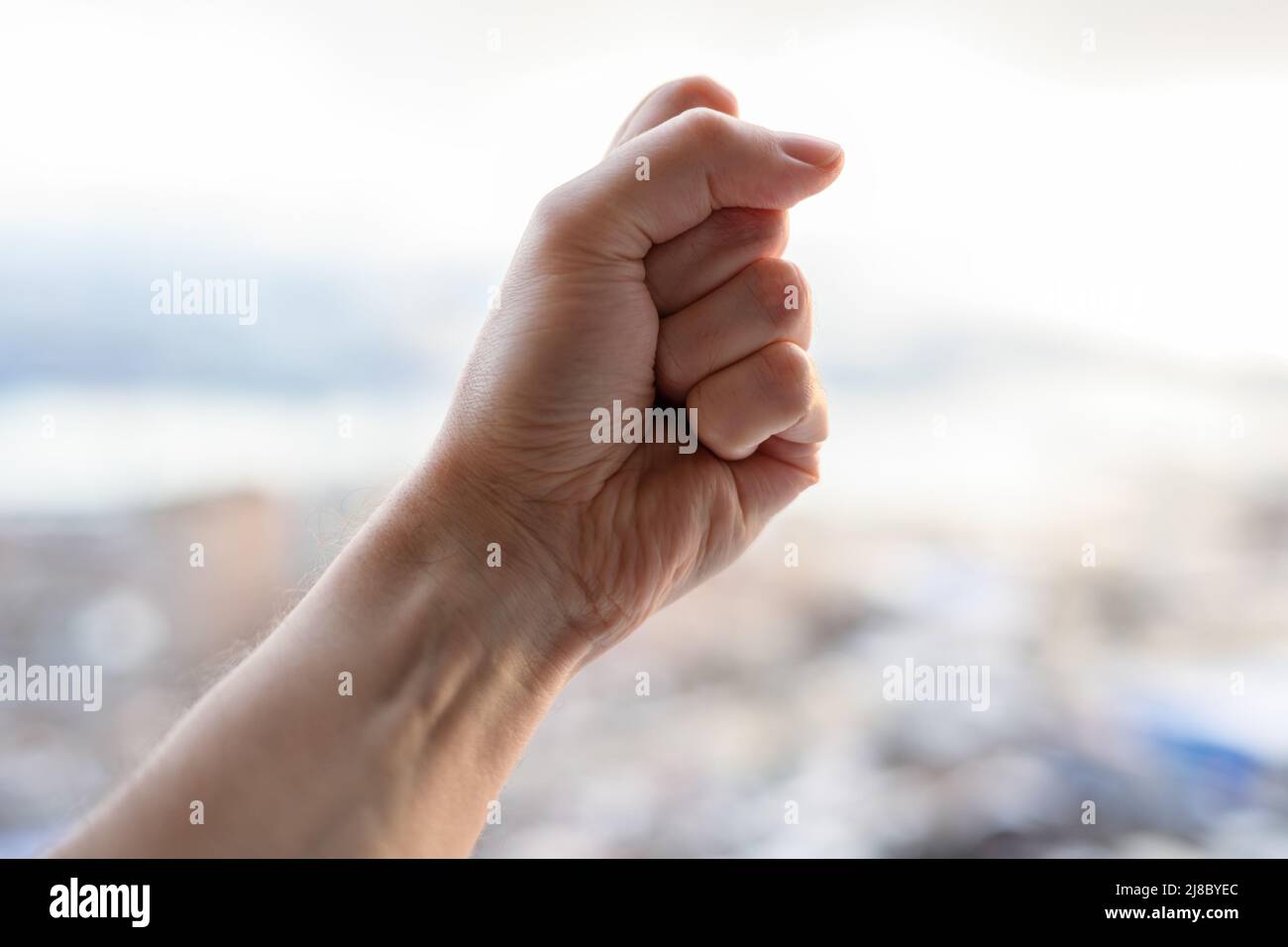 Hand of a man reaching to towards sky Stock Photo - Alamy