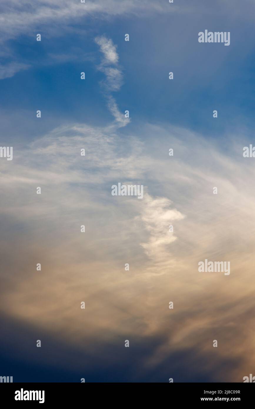 Sun disappearing behind cloud cover Stock Photo - Alamy