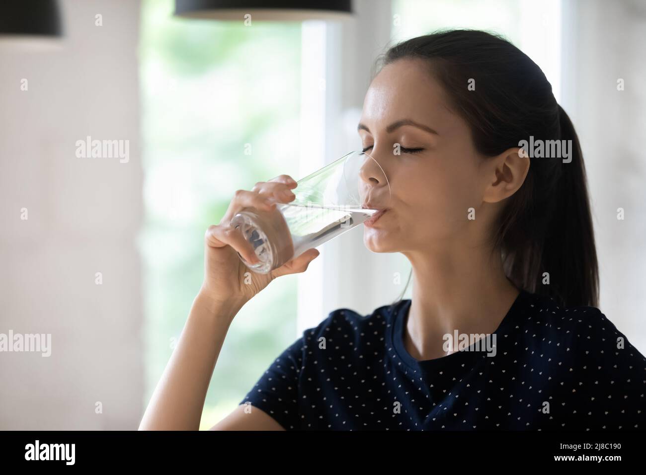 Thirsty dehydrated young woman drinking cold clean water Stock Photo - Alamy
