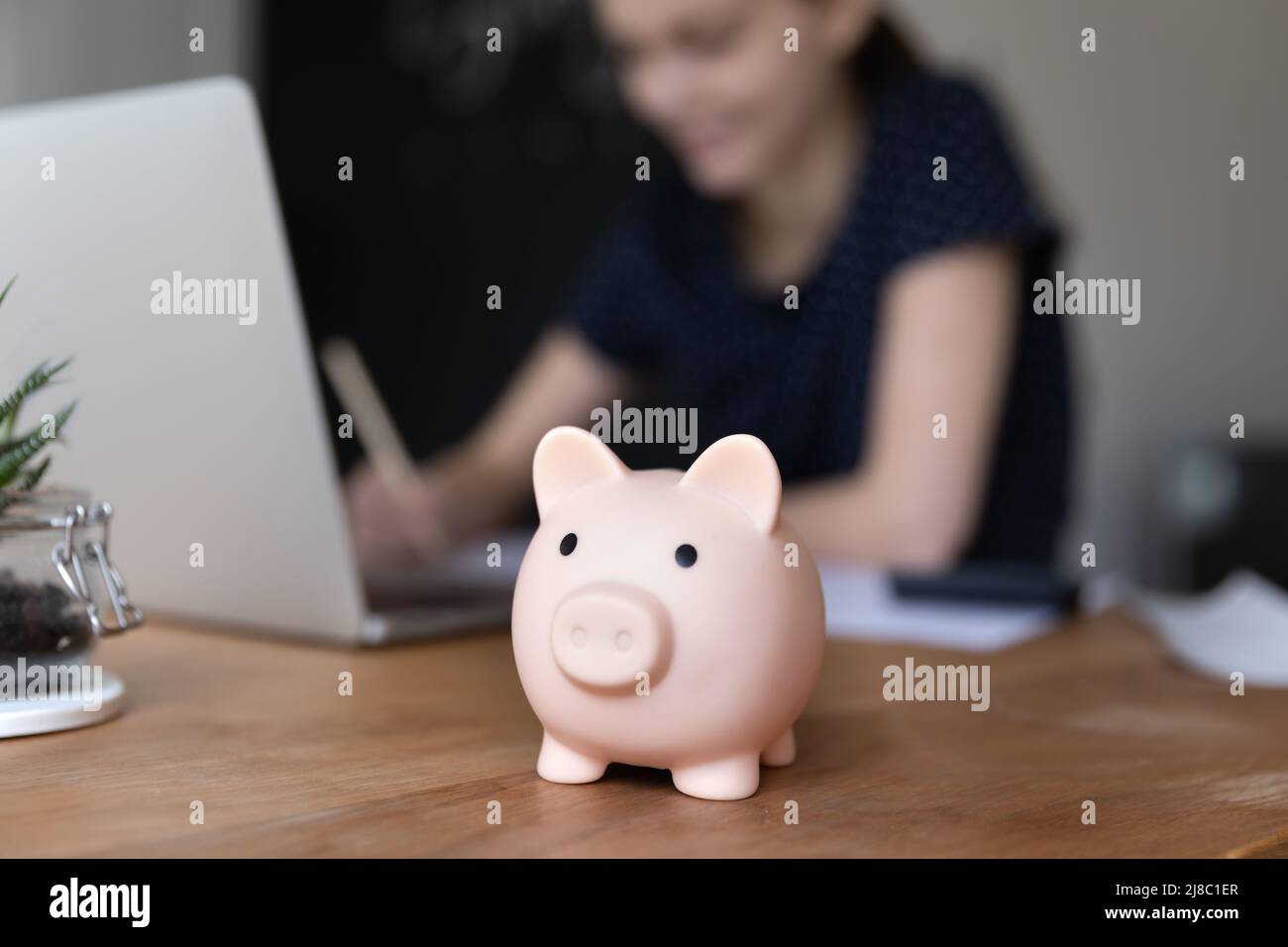 Pink piggy bank object on work desk of renter Stock Photo - Alamy