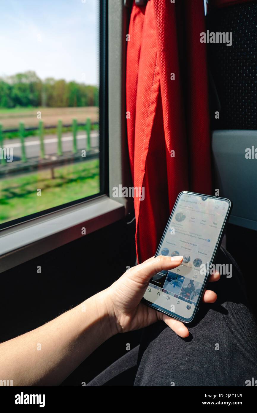 phone in woman hand riding on bus Stock Photo - Alamy