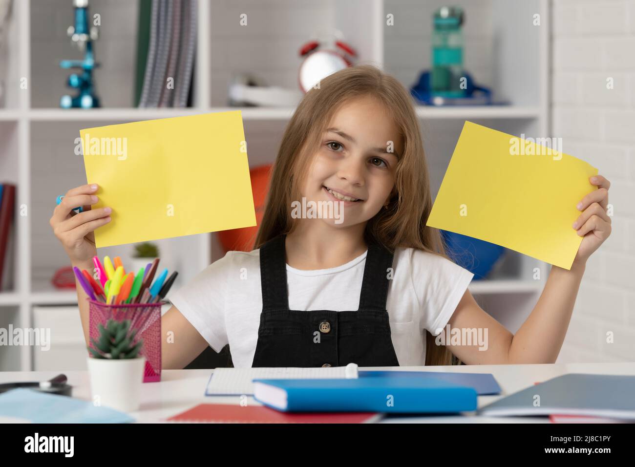 happy child hold paper in school classroom. copy space Stock Photo - Alamy