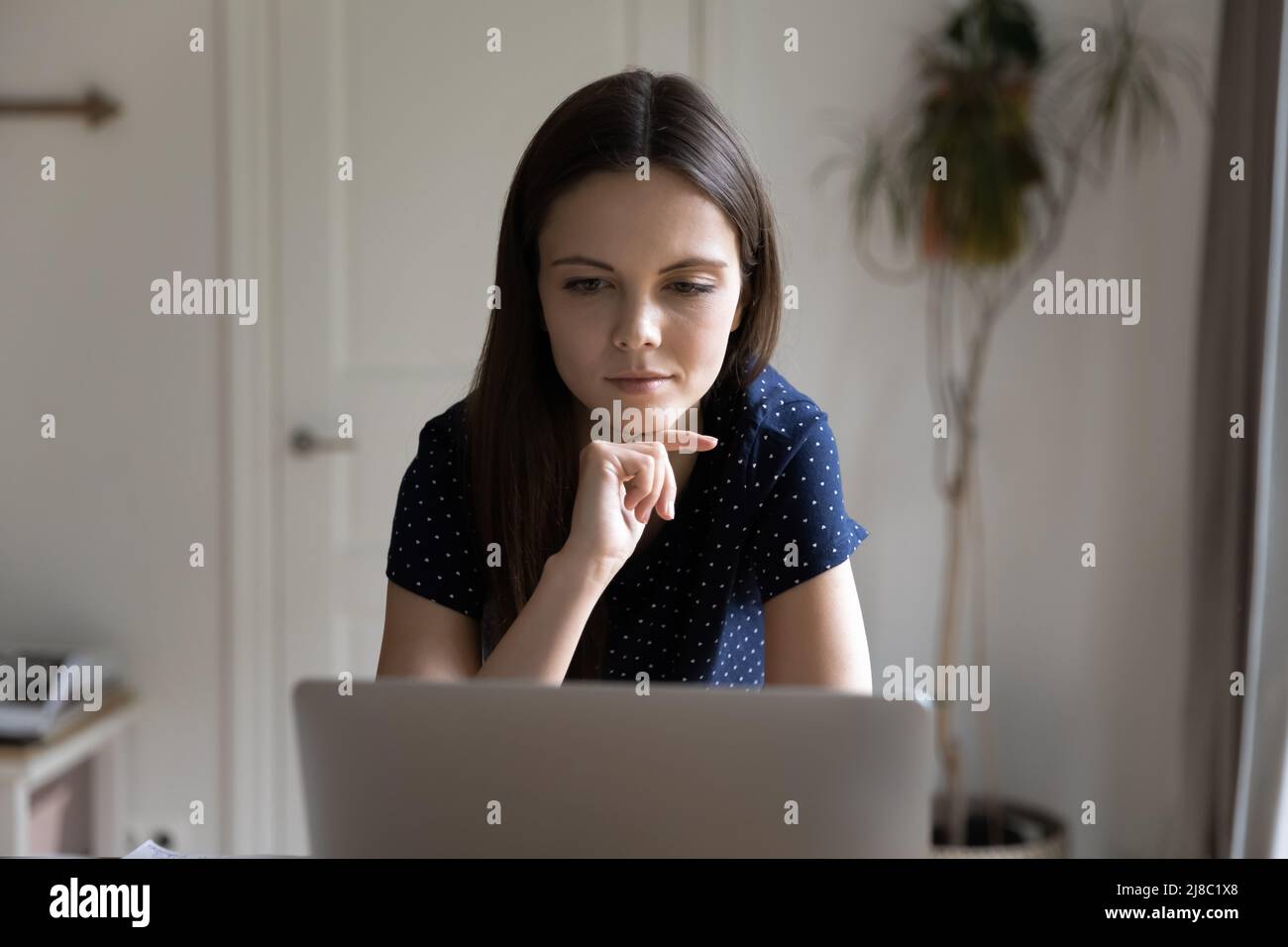 Thoughtful serious student girl thinking over research study Stock ...
